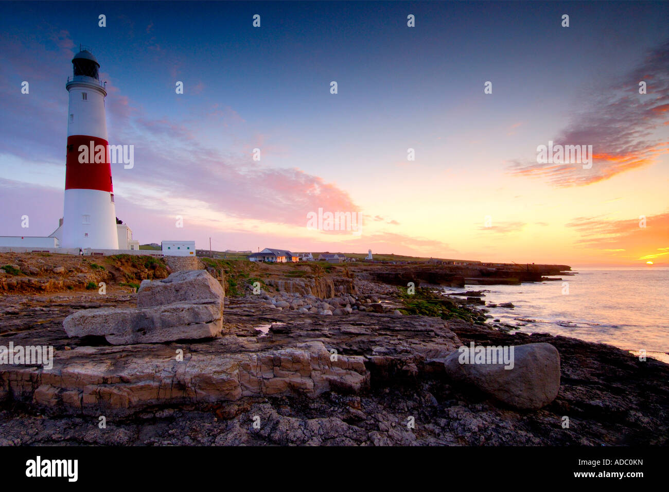 Portland Bill lighthouse at dawn taken from the foreshore amongst the ...