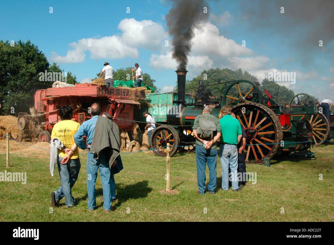 Marshall threshing drum driven by agricultural traction engine at work ...