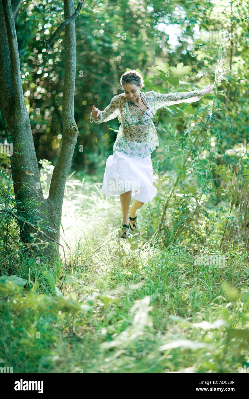 Young woman running through woods Stock Photo - Alamy