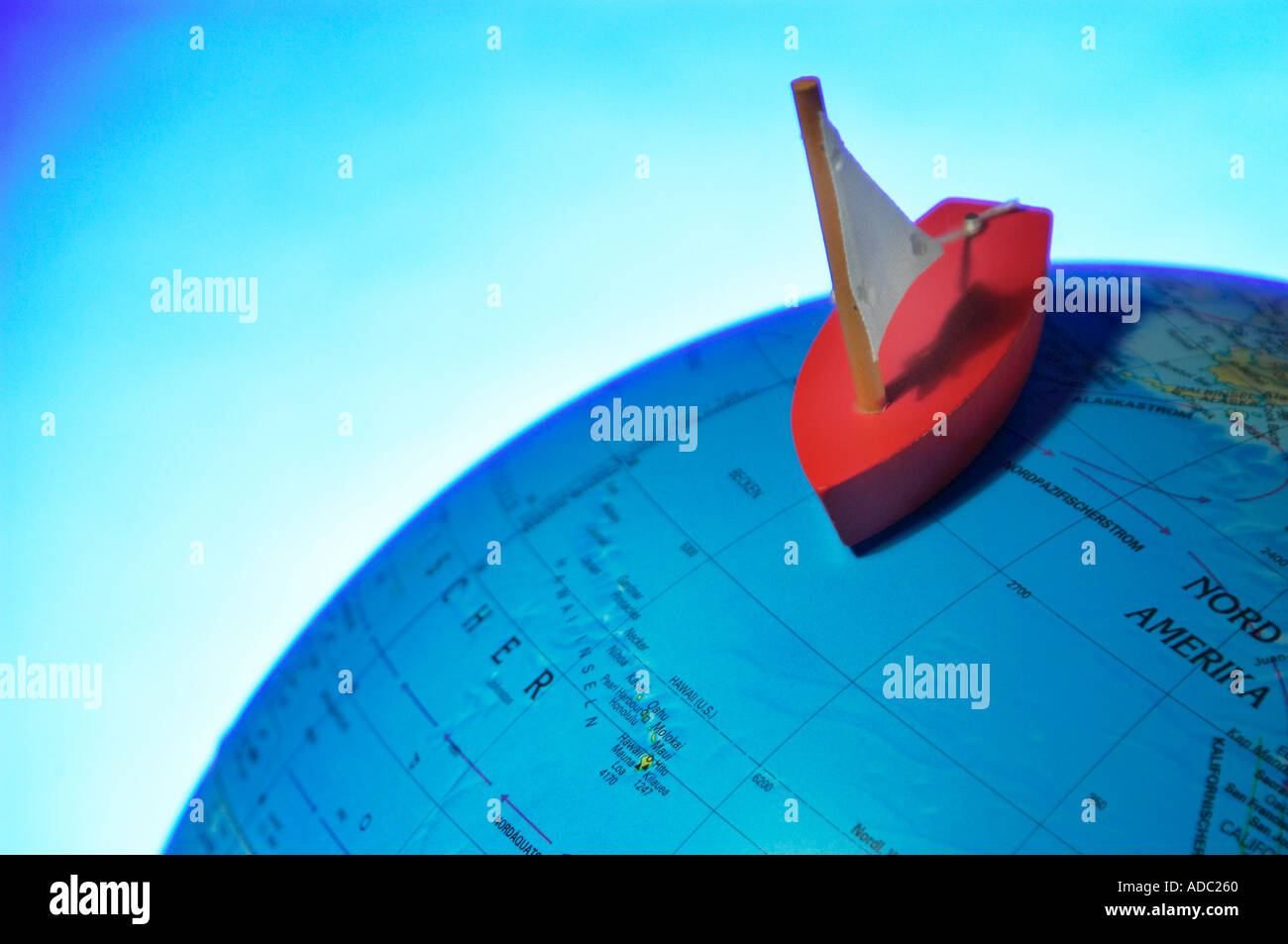 Boat on a globe Stock Photo - Alamy