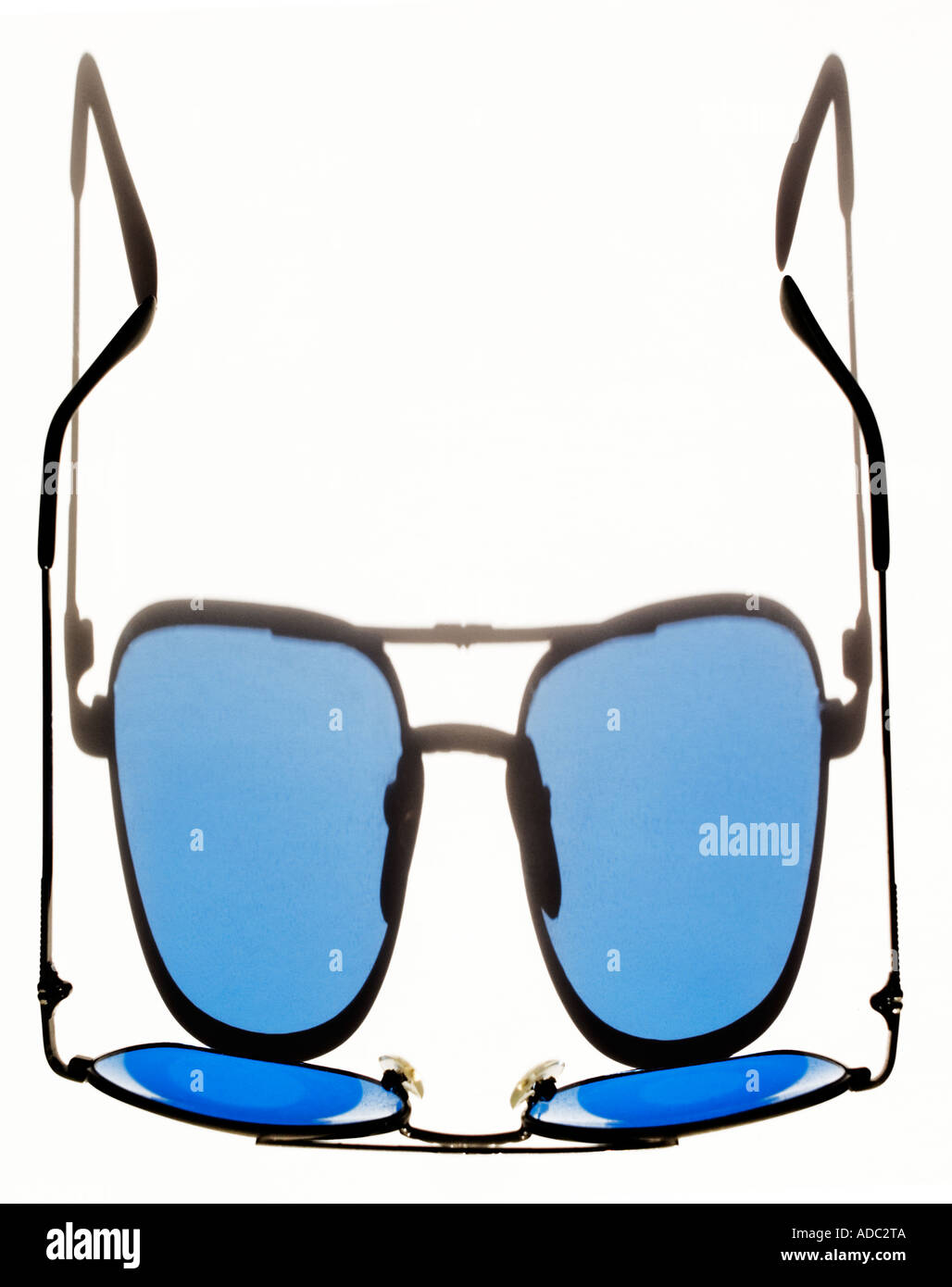 Shadow cast by a pair of sunglasses with blue lenses Stock Photo - Alamy