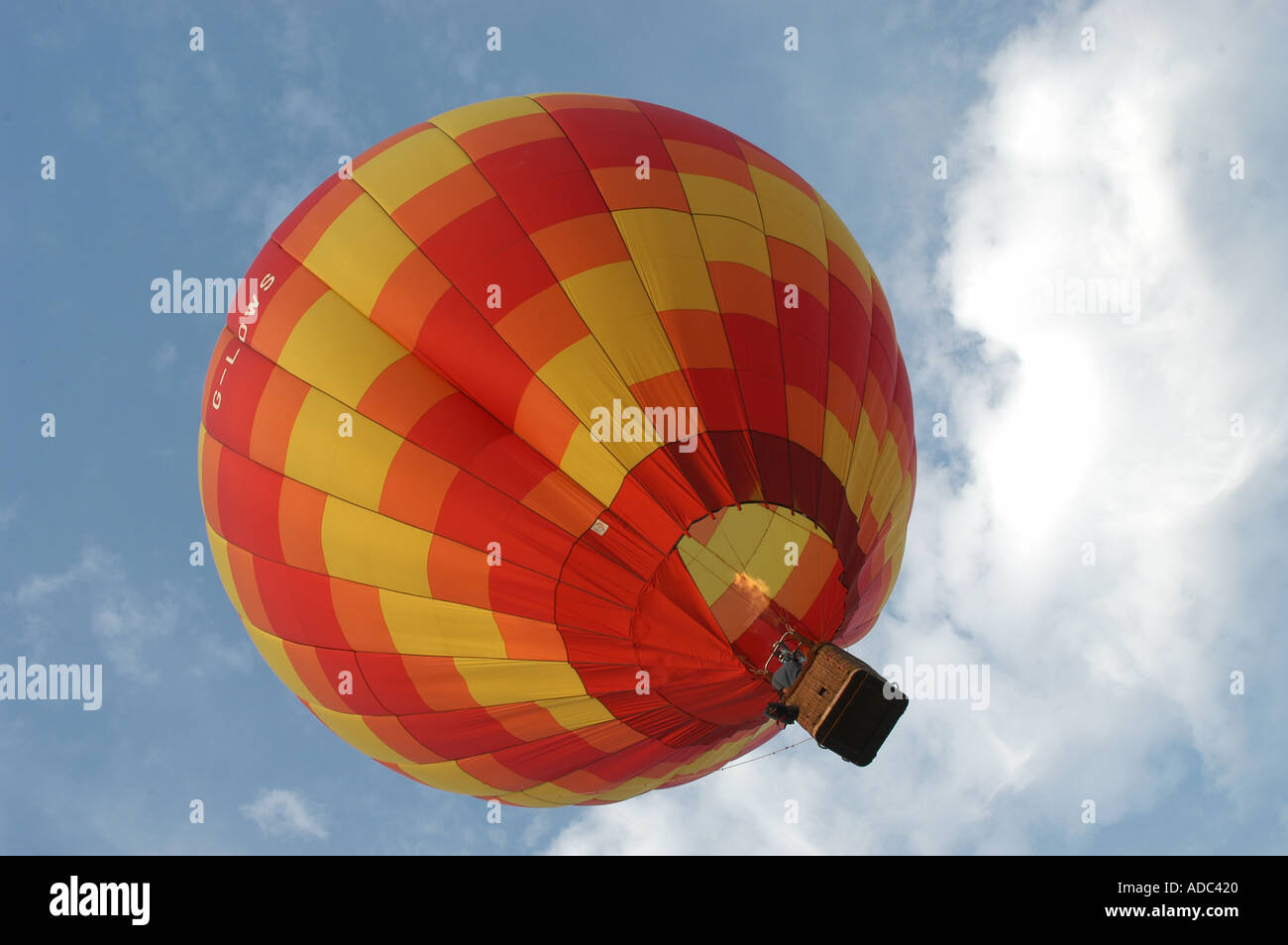 Red and yellow hot air balloon being inflated Stock Photo - Alamy