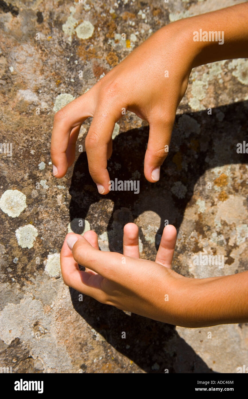 Female hands casting shadow over mold stained stone Stock Photo - Alamy