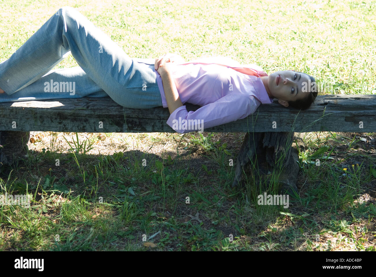 Businesswoman lying on bench, outdoors Stock Photo - Alamy