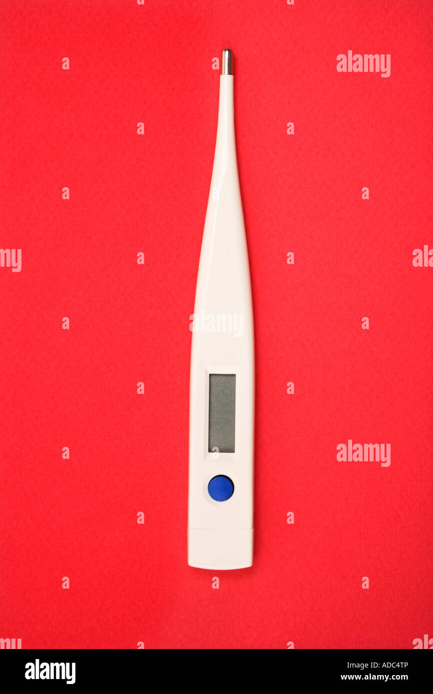 Digital thermometer on red background Stock Photo - Alamy