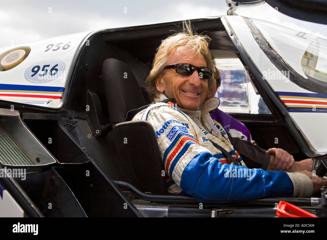 Derek Bell waiting to display a classic Rothmans 956 Porsche race ...