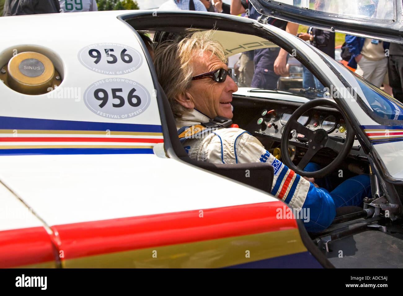 Derek Bell waiting to display a classic Rothmans 956 Porsche race ...