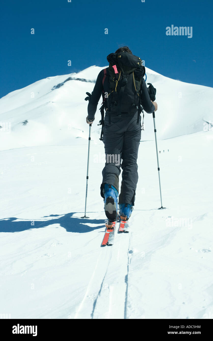 Skier heading toward mountain, rear view Stock Photo - Alamy