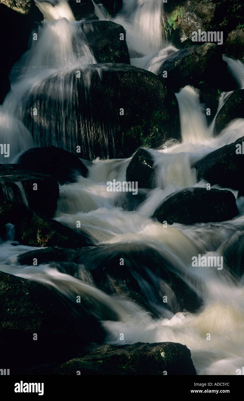 river water rushing over rocks at bottom of waterfall devon england uk ...