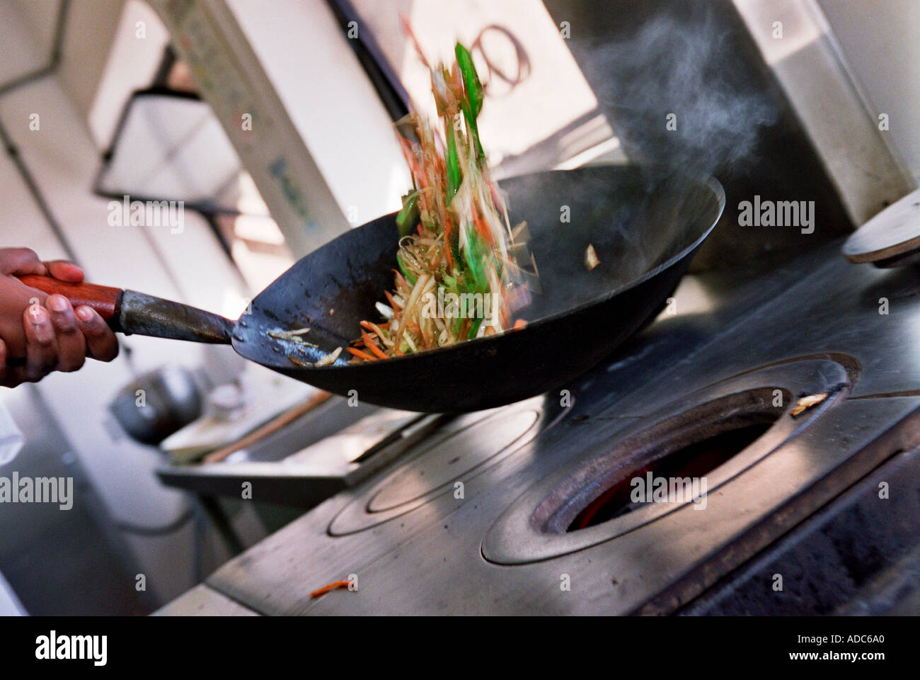 person cooking thai stir fry in restaurant close up Stock Photo - Alamy