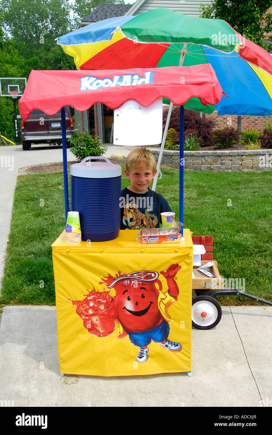 6 year old boy selling liquid refreshment at a sidewalk stand Stock ...