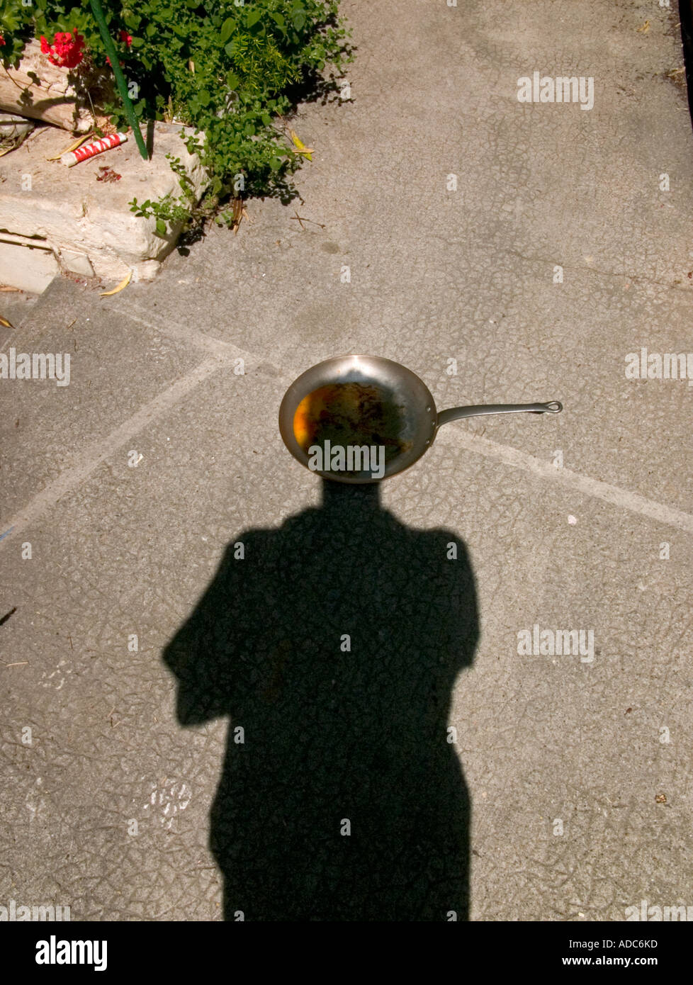 a shadow of an adult figure falls across the ground with the head ...