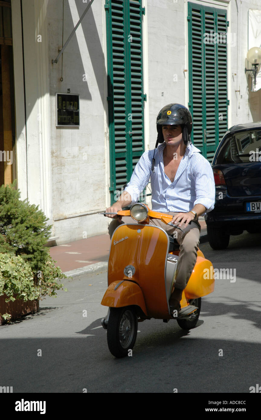 Italian man riding a scooter Stock Photo - Alamy