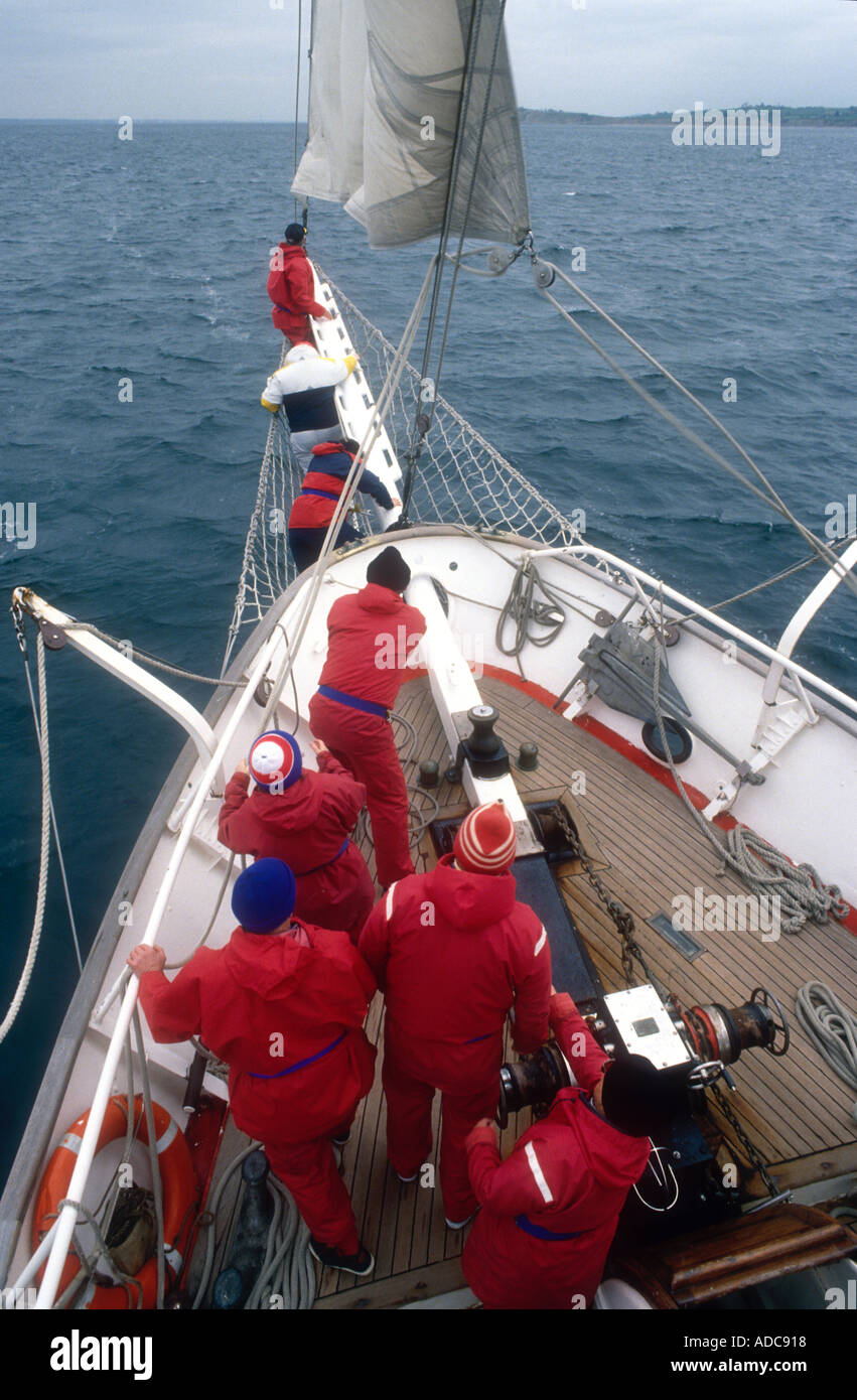 Raising a foresail aboard the British 1971 sail training brig Royalist ...
