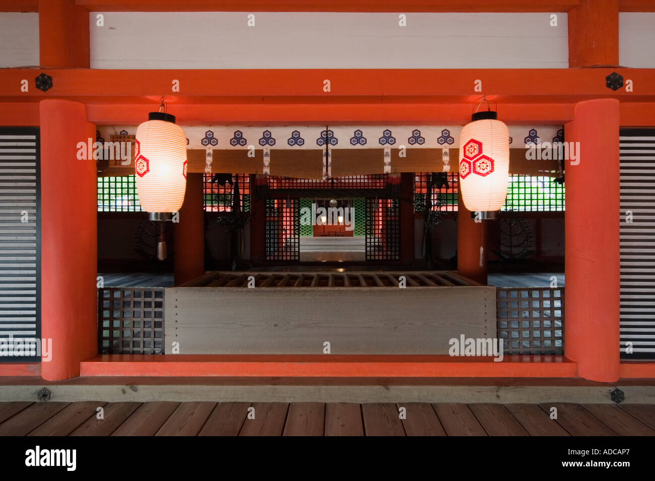 Paper lanterns hang over an Osaisen bako offering box at Itsukushima ...