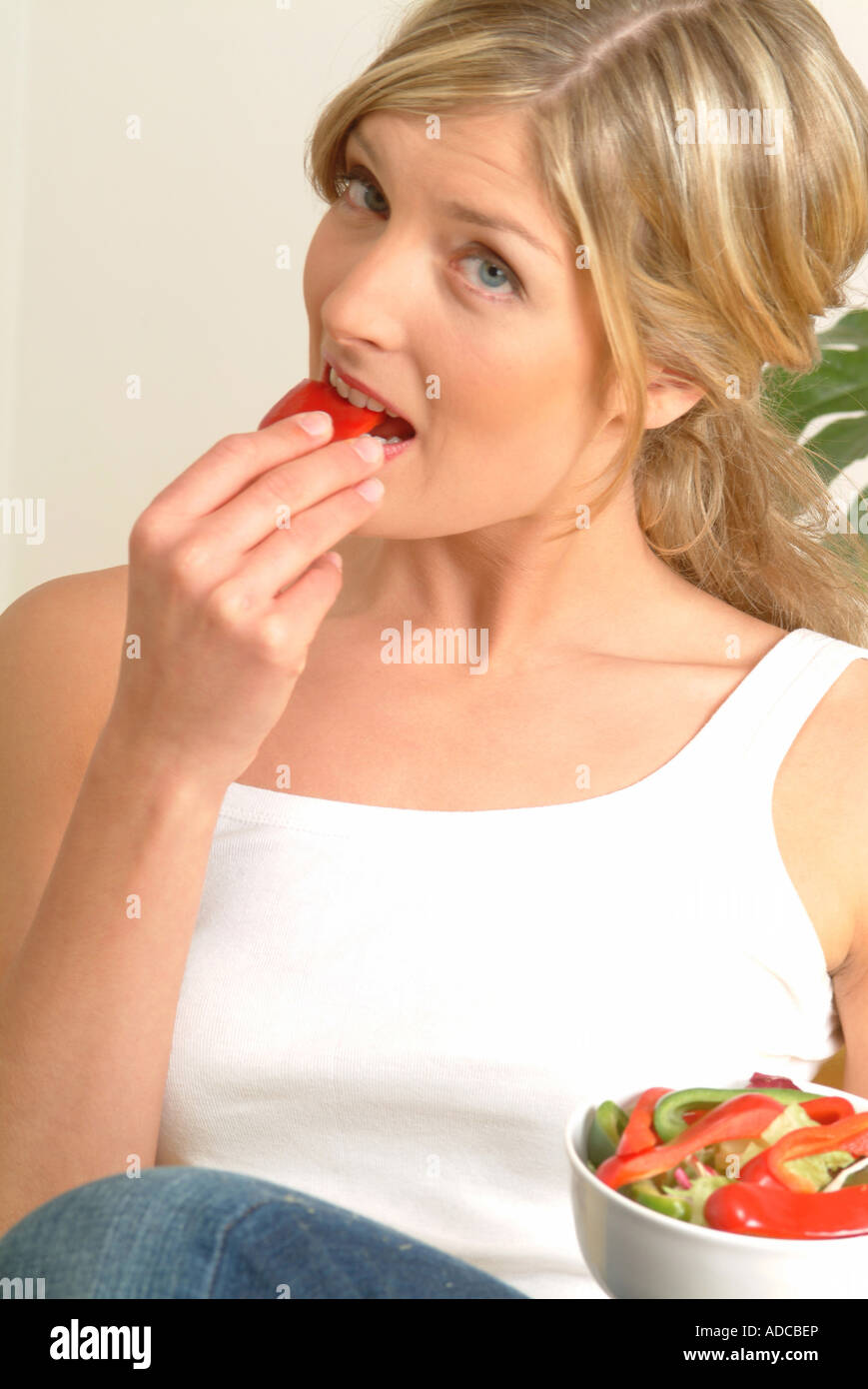 Woman eating red pepper Stock Photo - Alamy