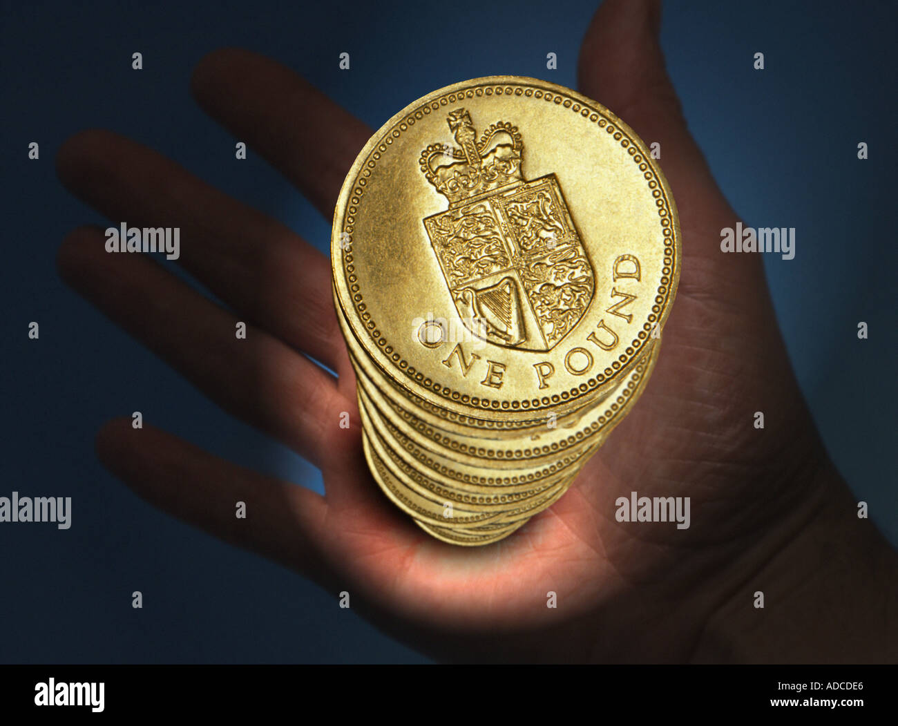 hand holding stack of UK Pound coins Stock Photo - Alamy
