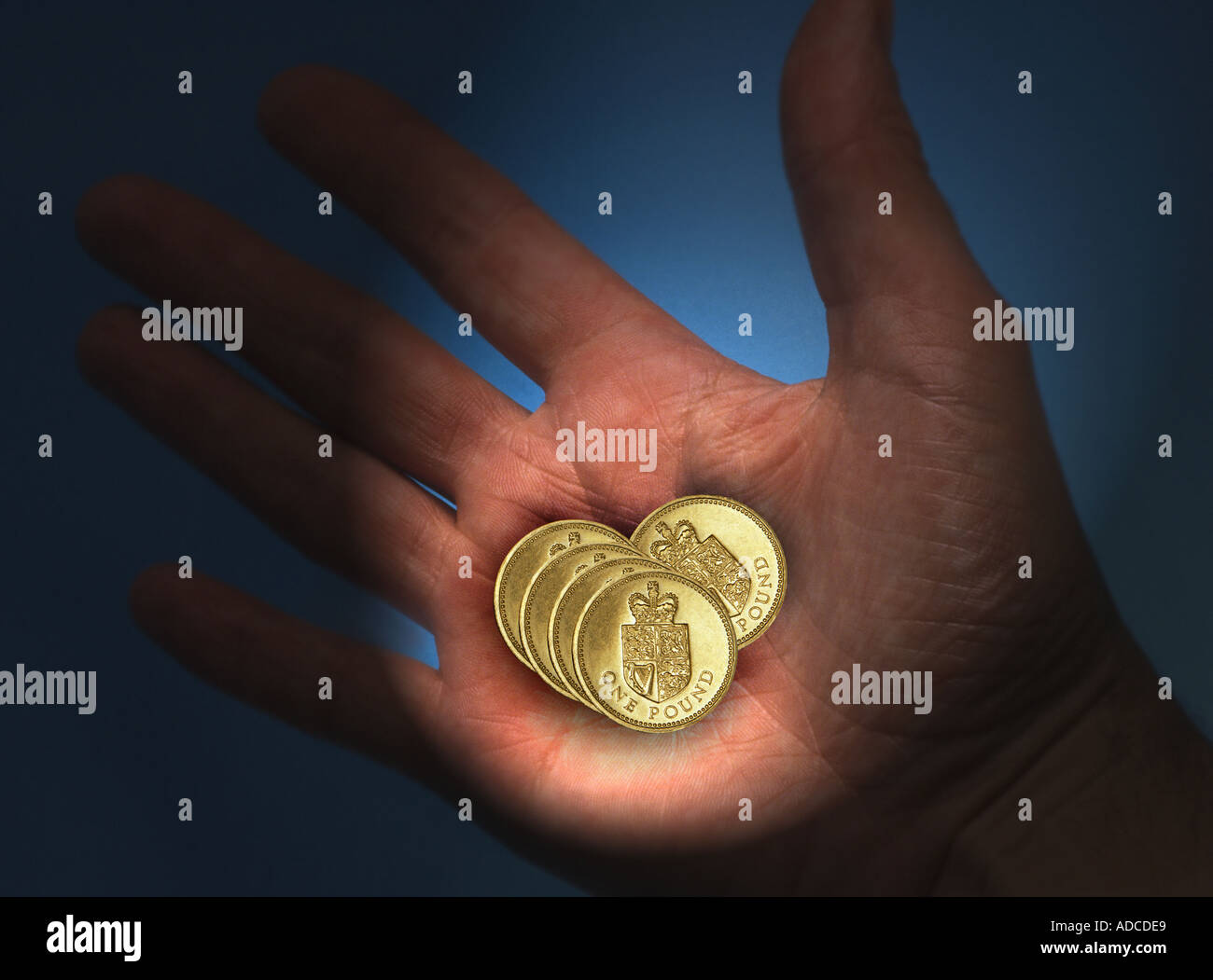 hand holding UK Pound coins Stock Photo - Alamy