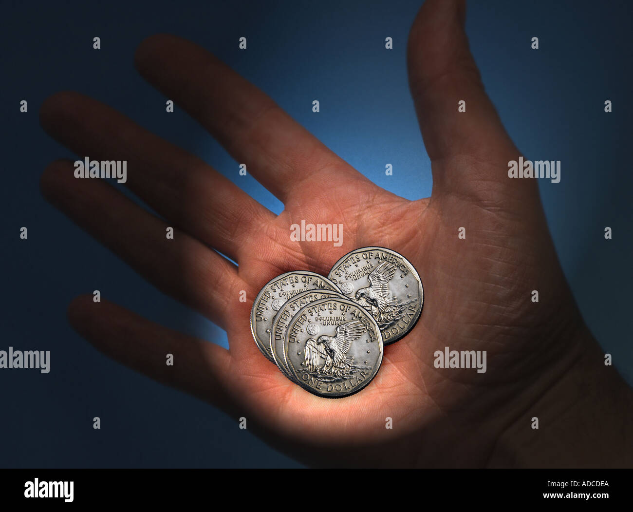 hand holding US Dollar coins Stock Photo - Alamy