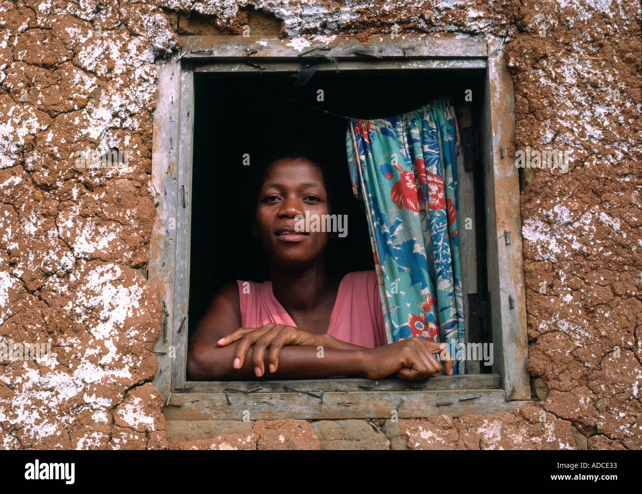 A woman framed in the window of her house, Ivory Coast Stock Photo - Alamy