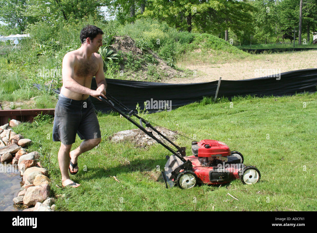 A man mowing the lawn Stock Photo - Alamy