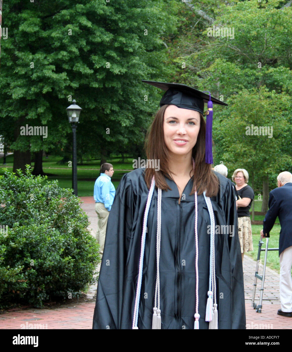 A graduate wearing a cap and gown Stock Photo - Alamy