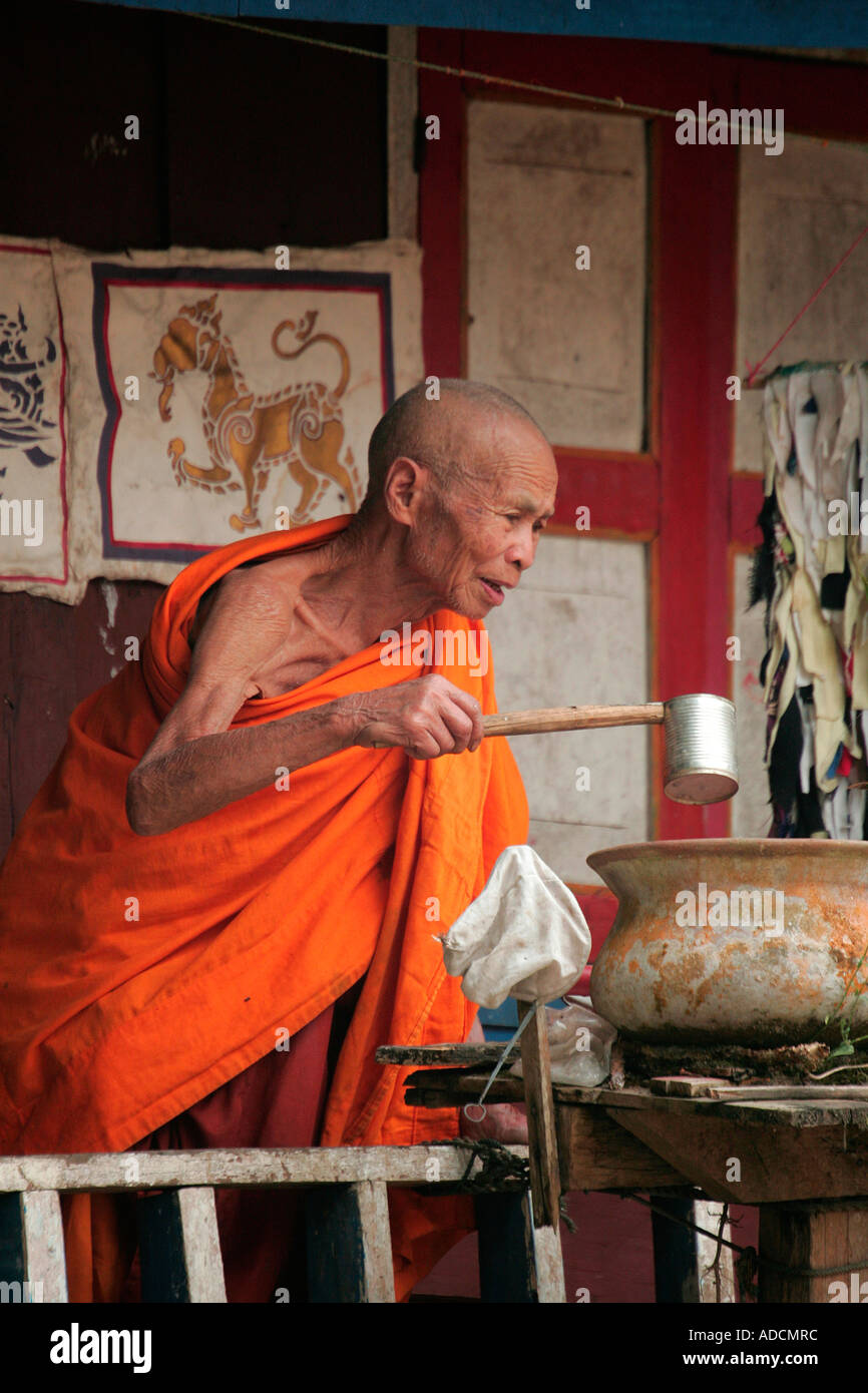 Buddhist monk drinking at the monastery at Baw village on the Mekong ...