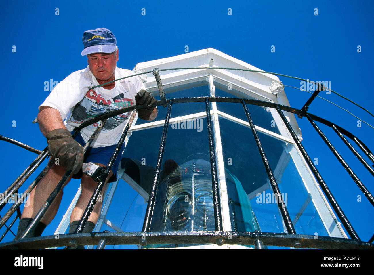 Lighthouse keeper must take care about lighthouse building He paints ...
