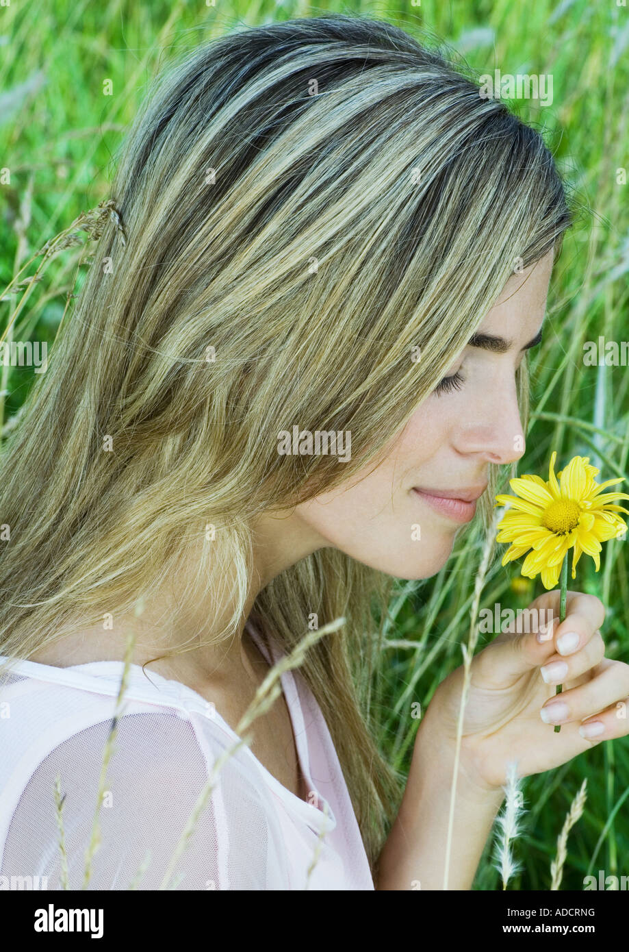 Woman smelling flower Stock Photo - Alamy