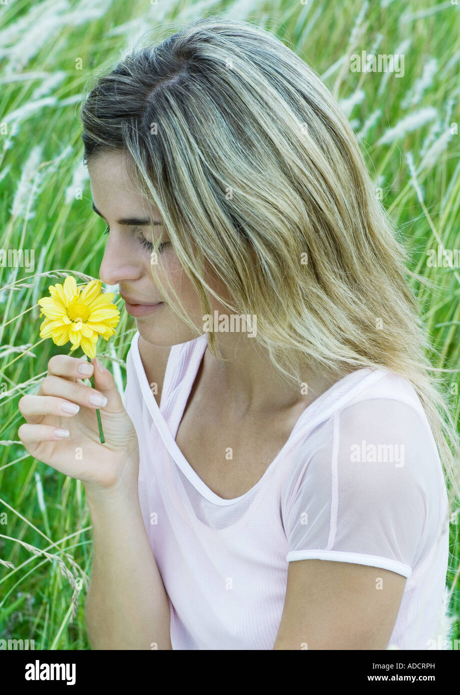 Woman smelling flower Stock Photo - Alamy