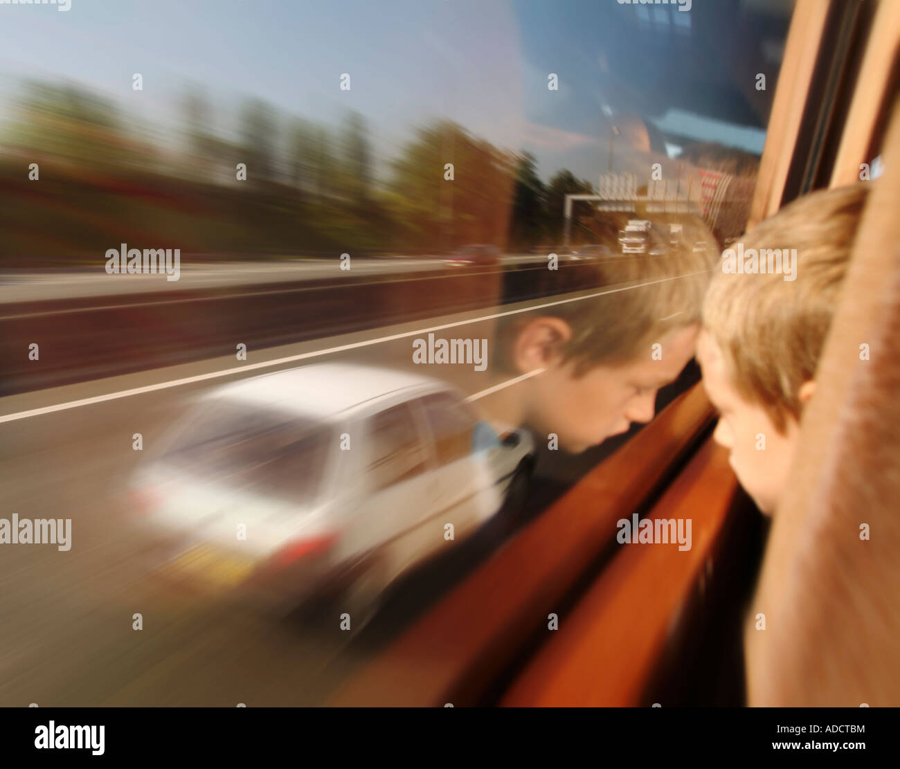 Young boy looking out of Coach Window on motorway Stock Photo - Alamy