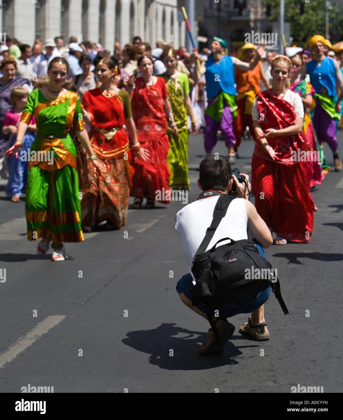 Photographer taking picture of dancing Hare Krishna women, performing ...
