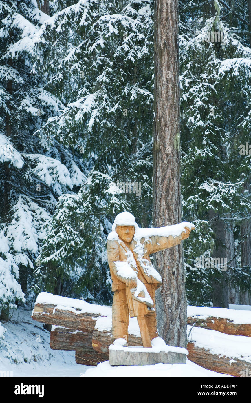 Wooden lumberjack by timber in snow Stock Photo - Alamy