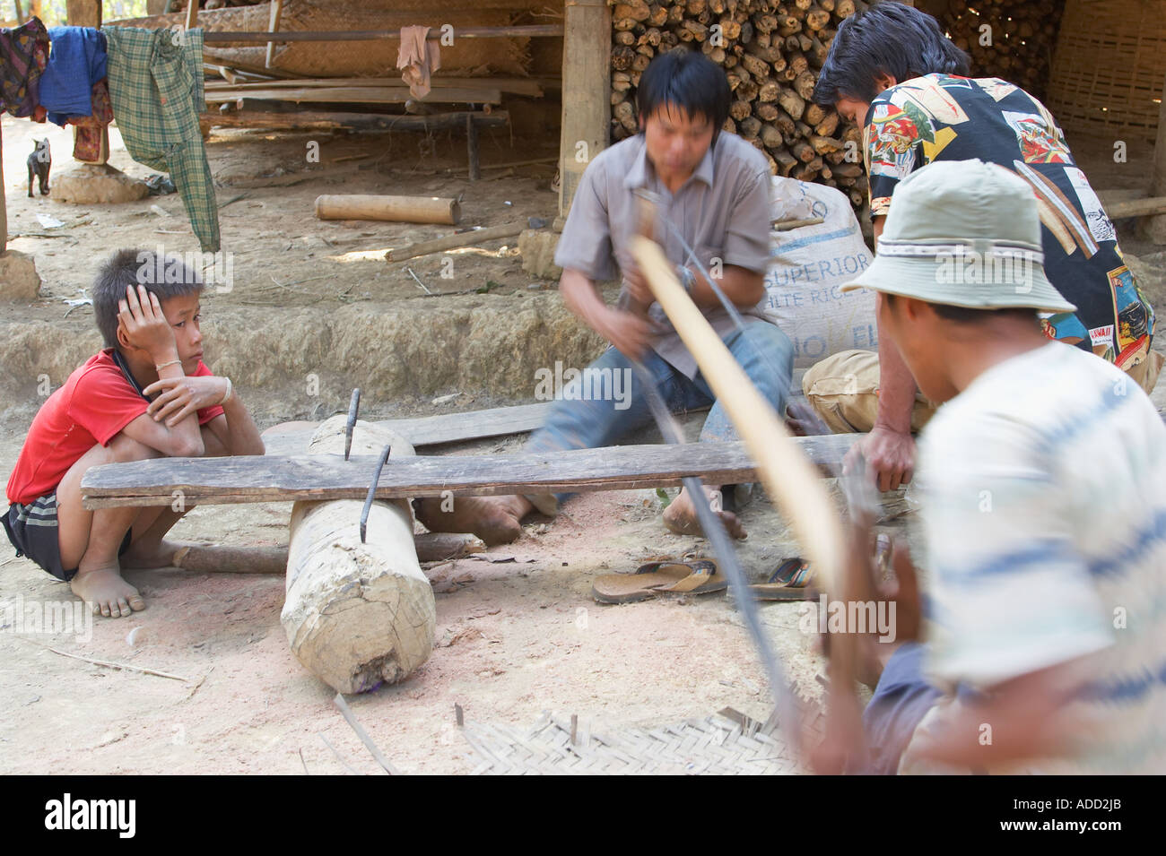 Men Cutting Plank Of Wood With Saw Stock Photo - Alamy