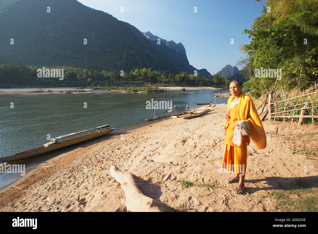 Monk Standing On Sandy Riverbank Stock Photo - Alamy