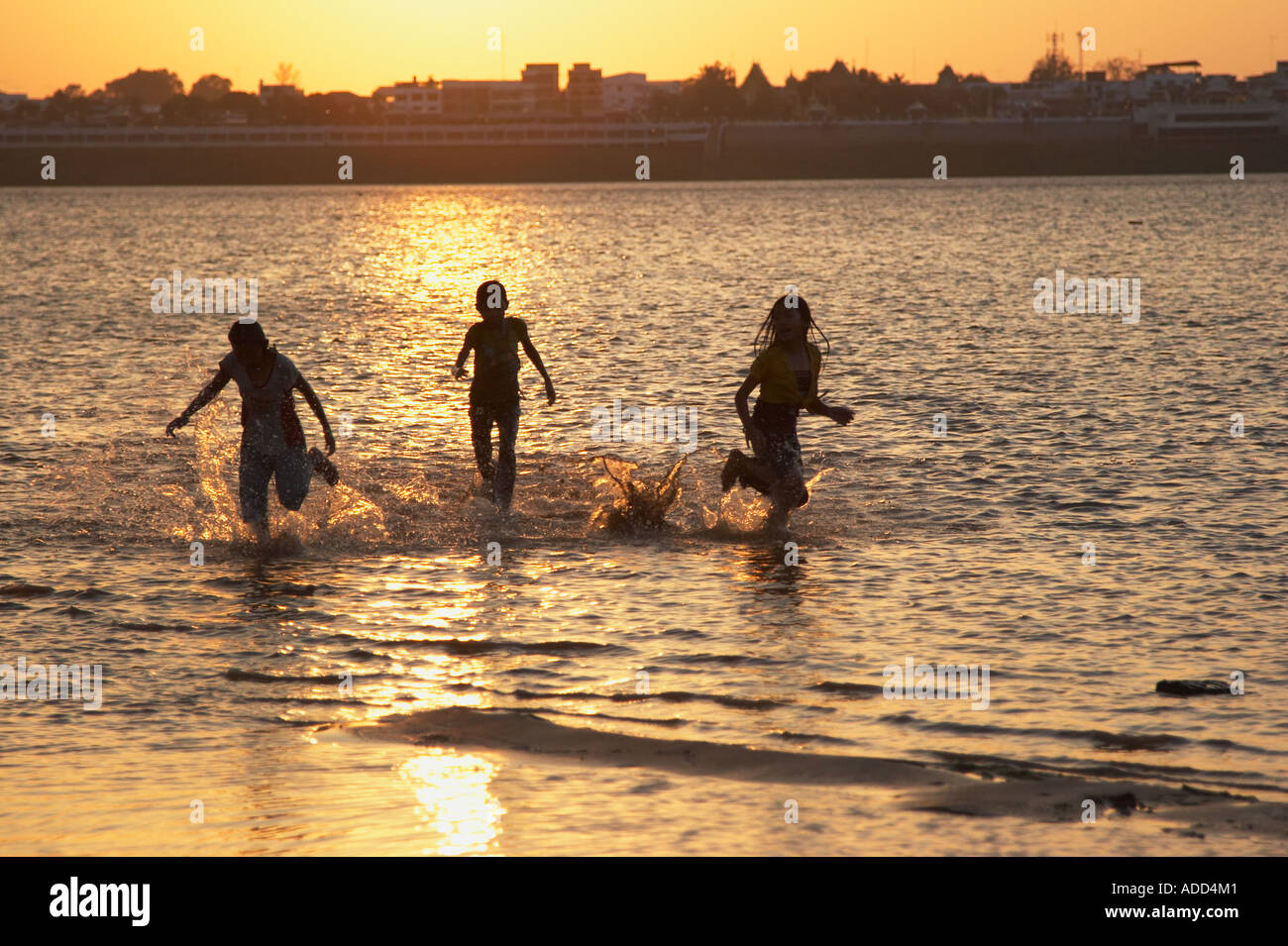 Three Children Running Out Of Mekong River Stock Photo - Alamy