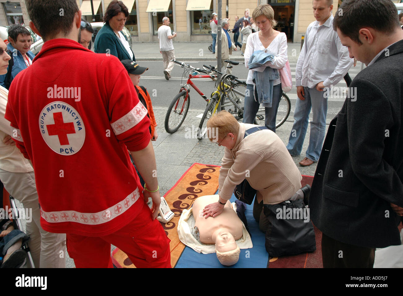 Emergency and first aid training on a street in Warsaw. People learing ...