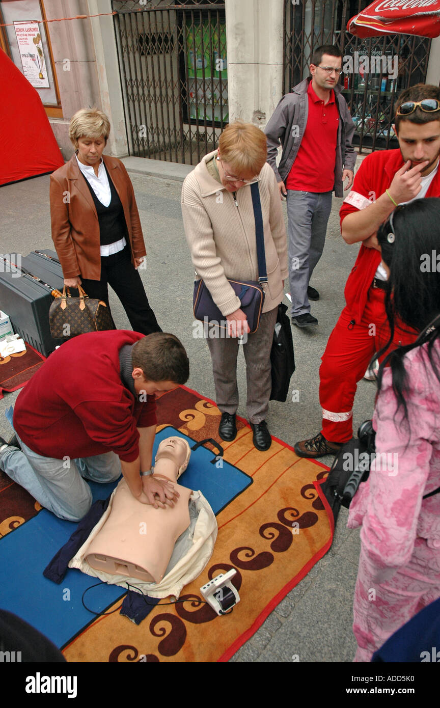 Emergency and first aid training on a street in Warsaw. People learing ...