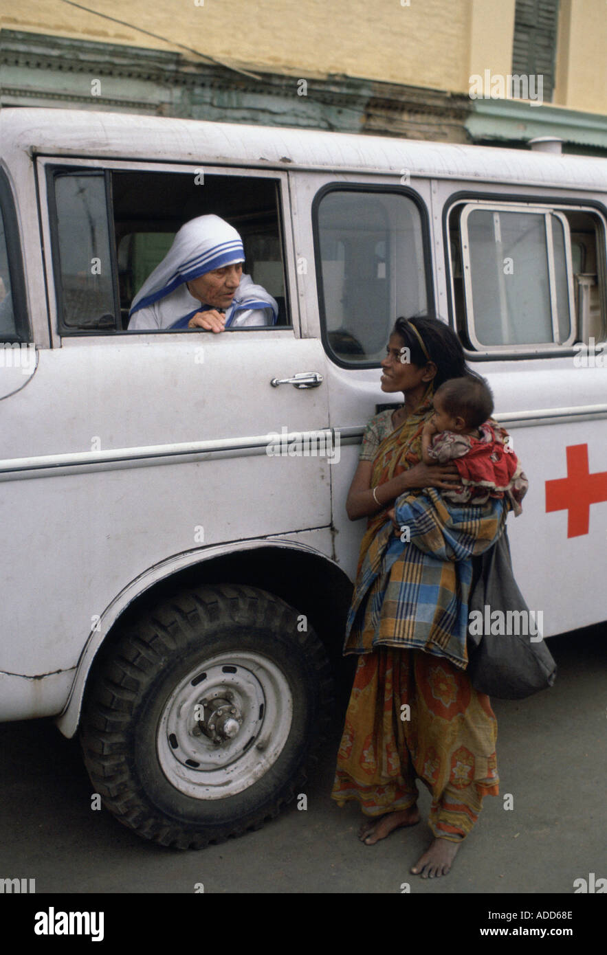 Mother Teresa talking with poor woman and child from a Red Cross ...