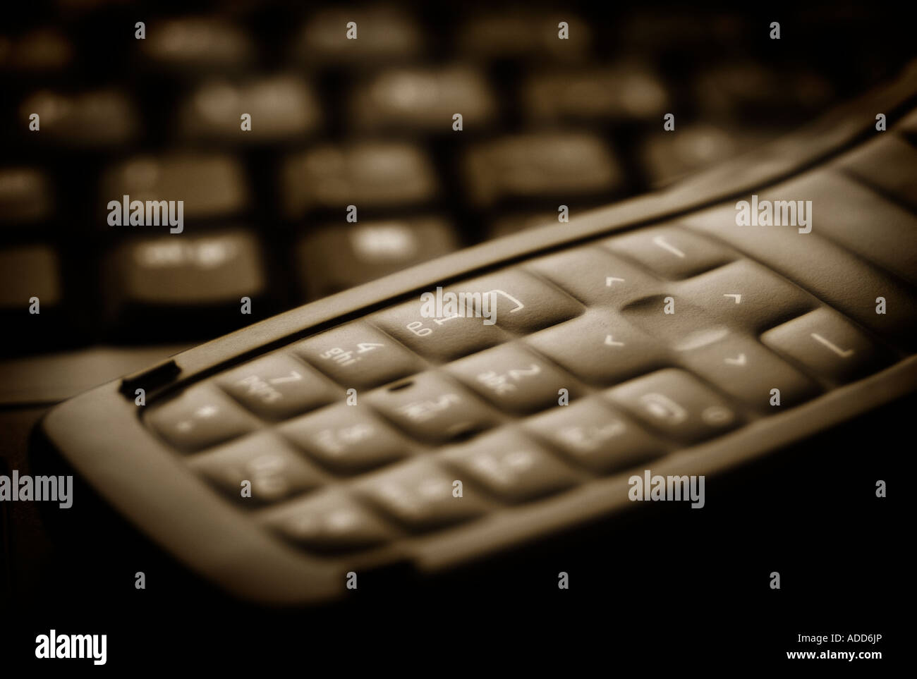Closeup detail of a cellular phone keypad and a laptop keyboard Stock ...