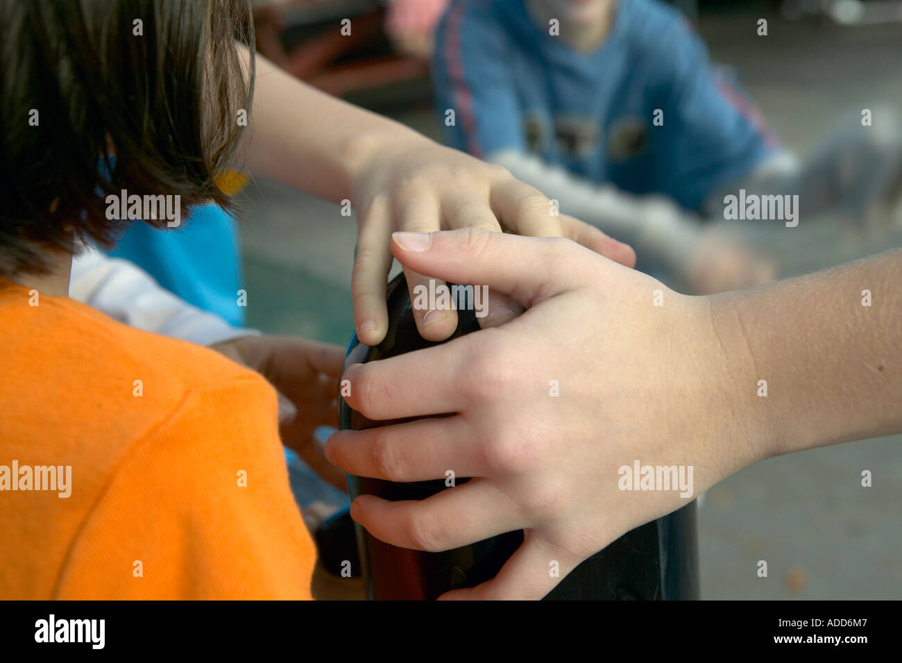 Children's hands on a pole playing a game Stock Photo - Alamy