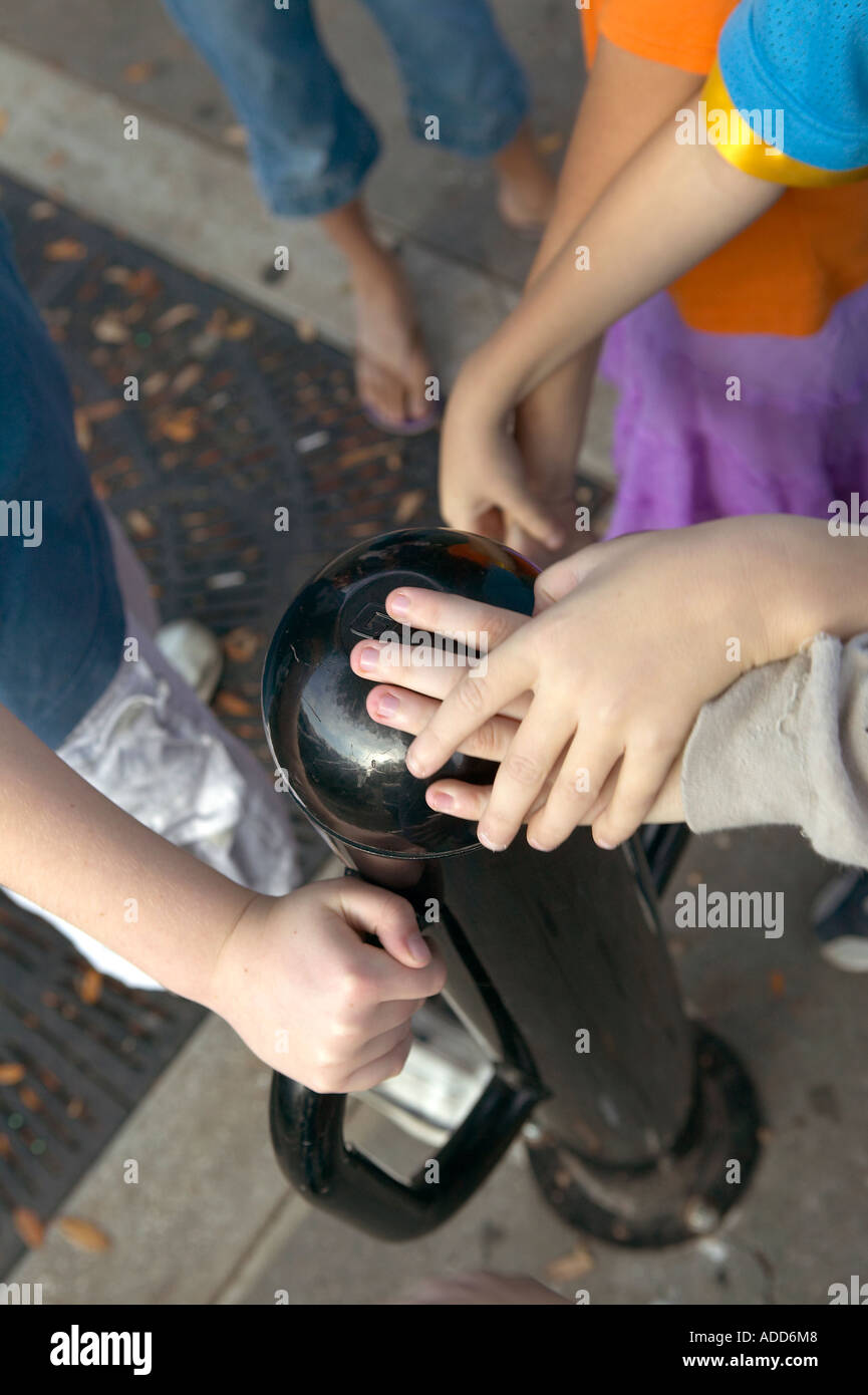 Children's feet in a circle with one hand in the center Stock Photo - Alamy