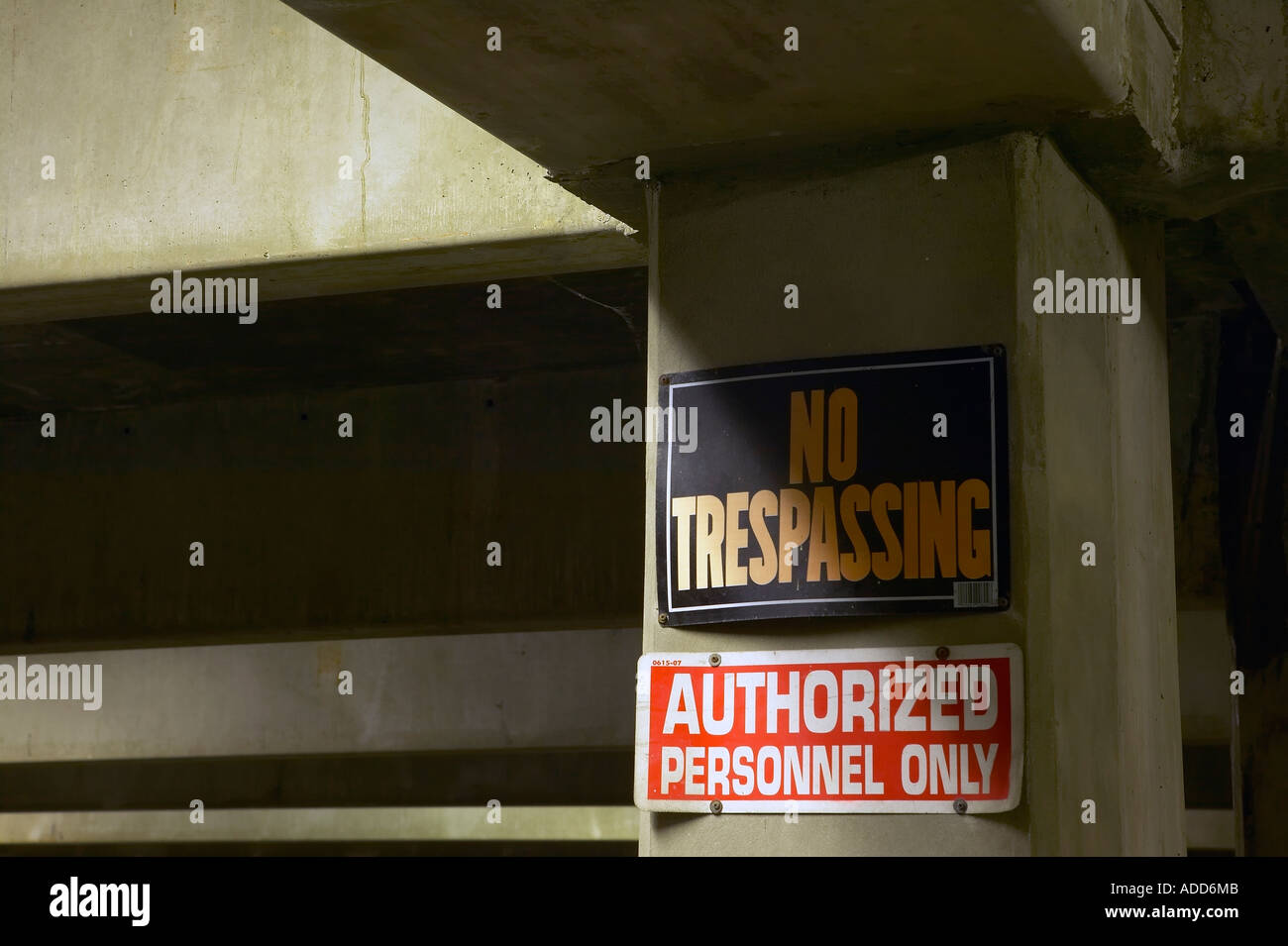 No Trespassing and Authorized Personnel Only signs posted on concrete ...