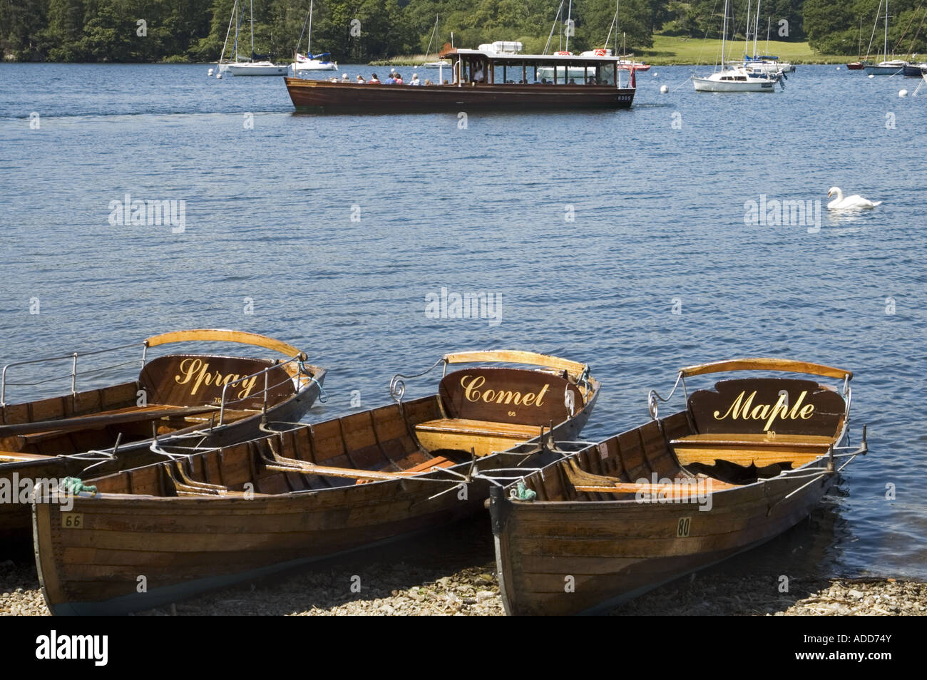 Three beached rowboats, cruise boat and sail boats in Amberside harbour ...