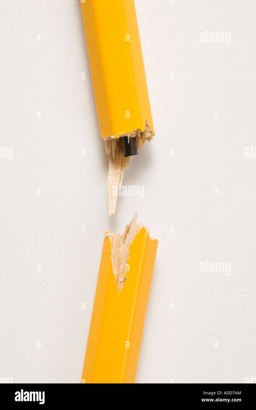 Wooden yellow pencil broken with lead exposed against white background ...