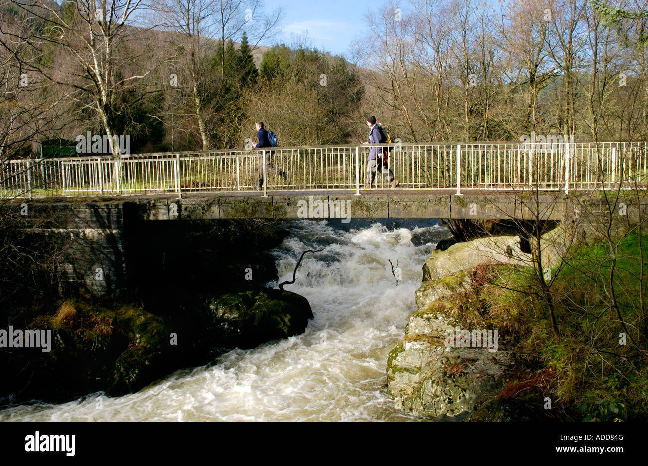 Walkers cross bridge over the River Irfon near Llanwrtyd Wells Powys ...