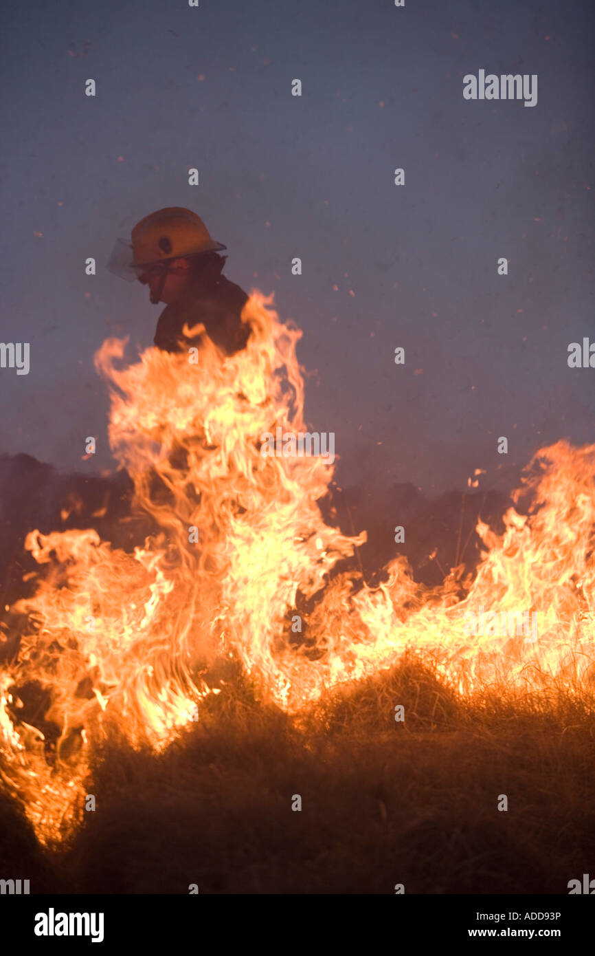 Fireman beating fire hi-res stock photography and images - Alamy