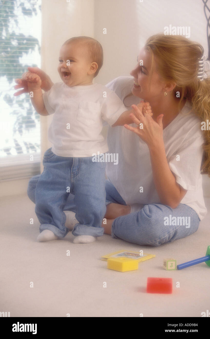 MOTHER TEACHING BABY TO WALK Stock Photo - Alamy
