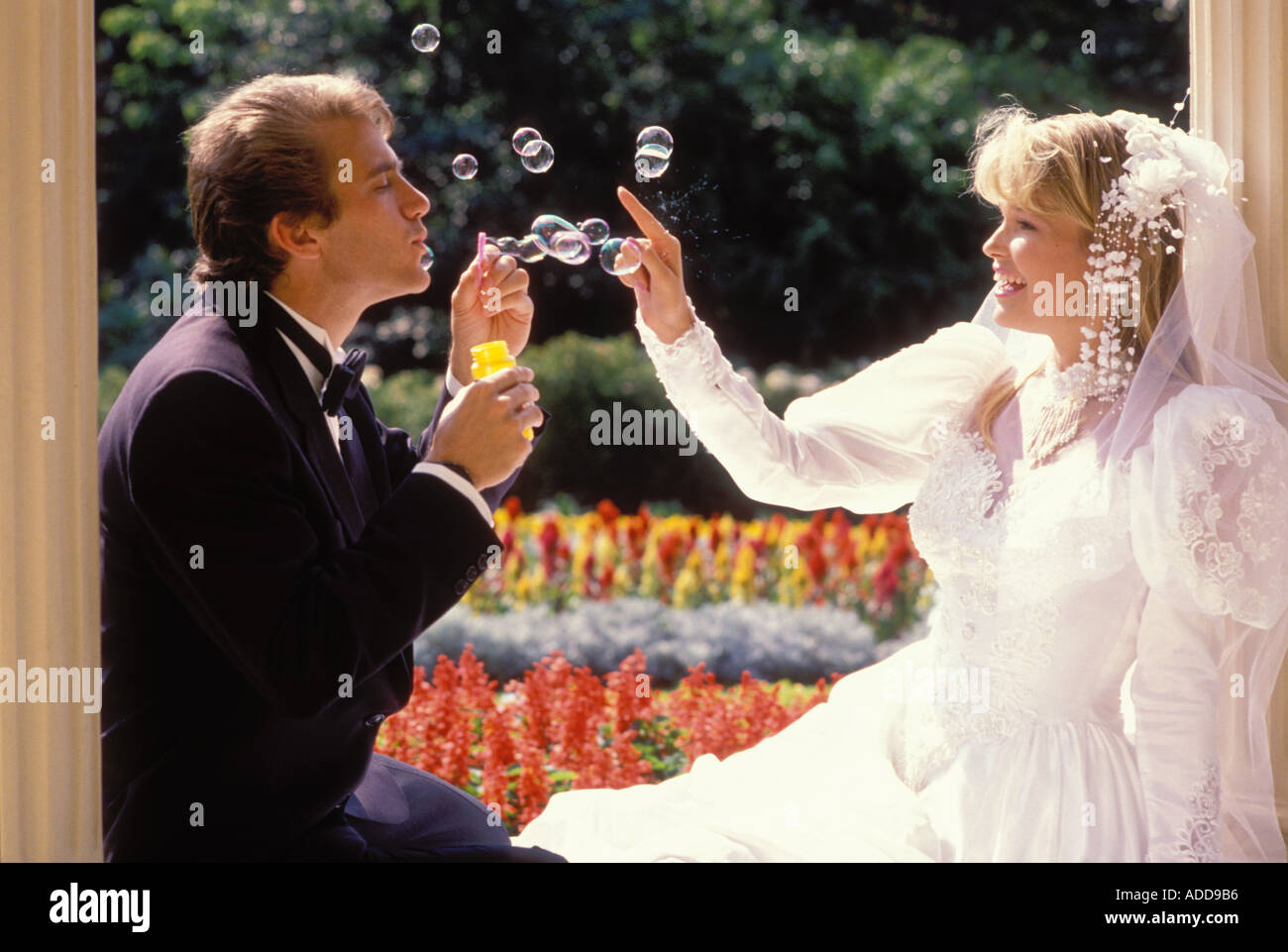 Wedding couple blowing bubbles Stock Photo - Alamy