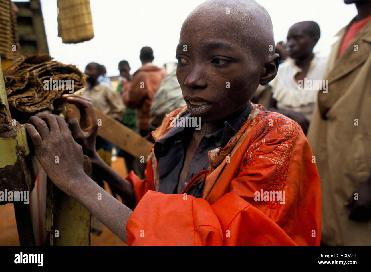 A weak young child arriving at a way station on the way back to Kigali ...